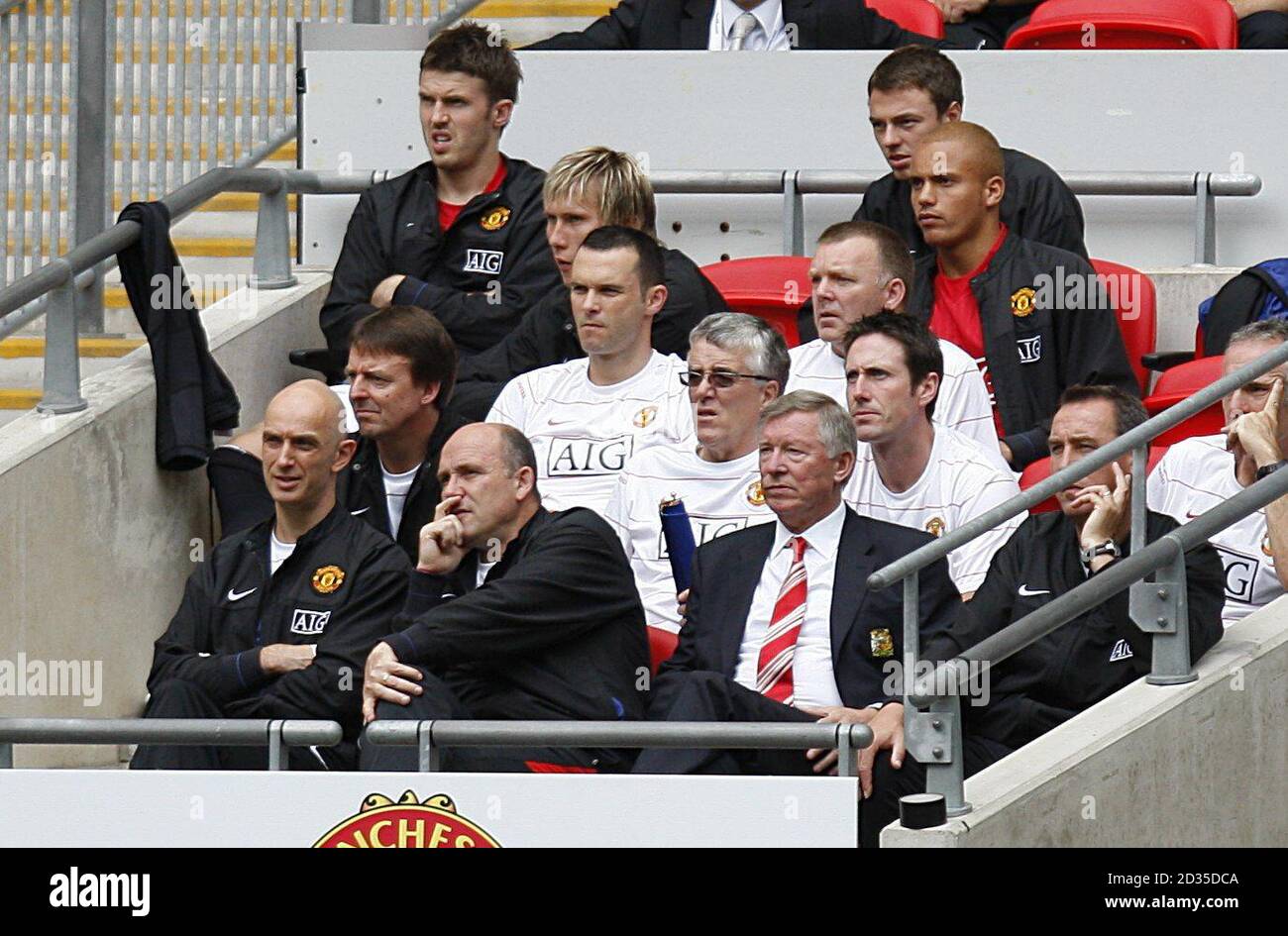 Manchester United's manager Alex Ferguson (right) watches from the ...