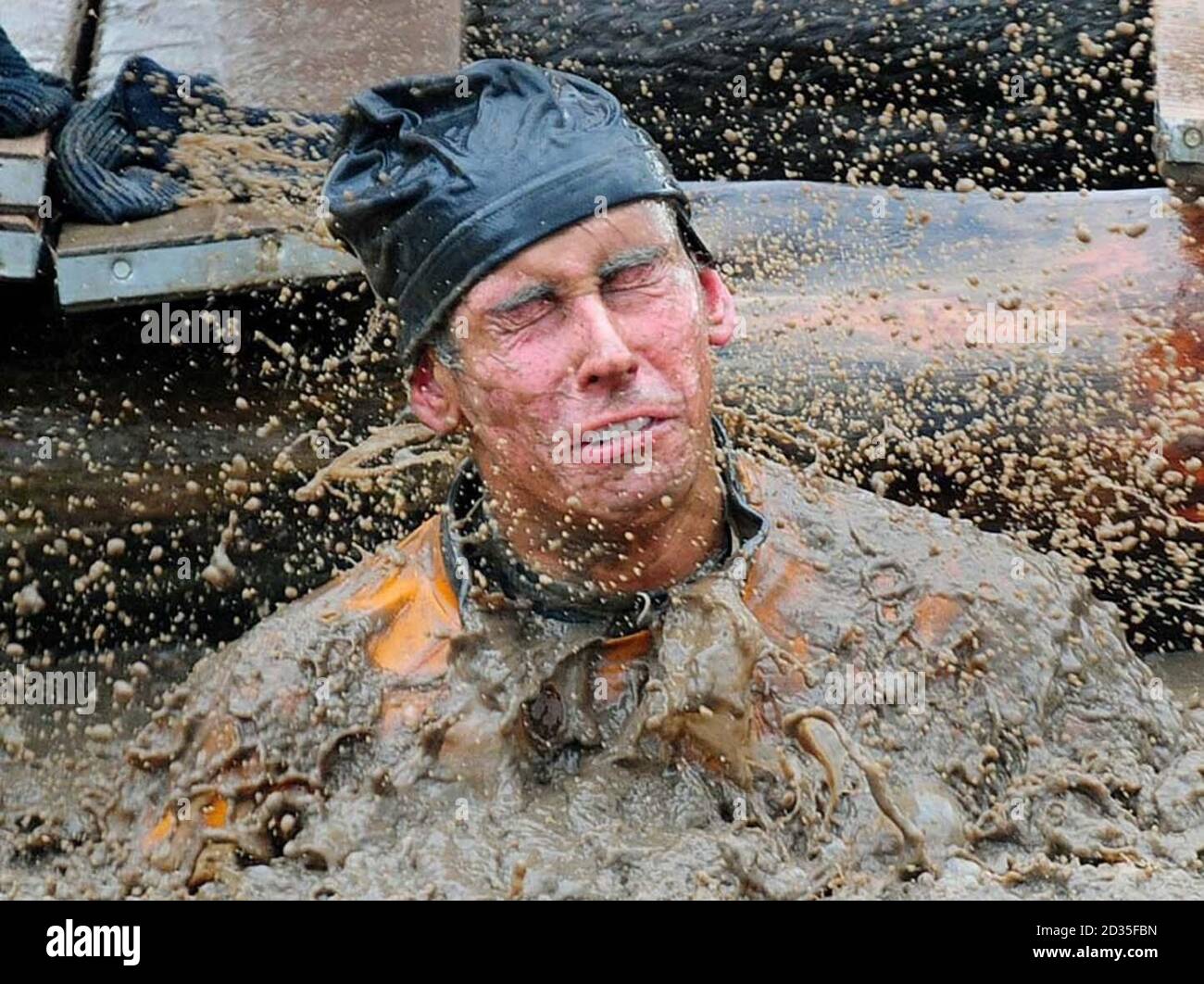 A competitor takes part in the Tough Guy 2009 endurance competition at ...