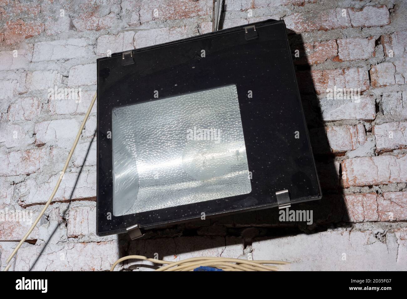 halogen lamp hanging on a brick wall halogen lamp isolated on white ...
