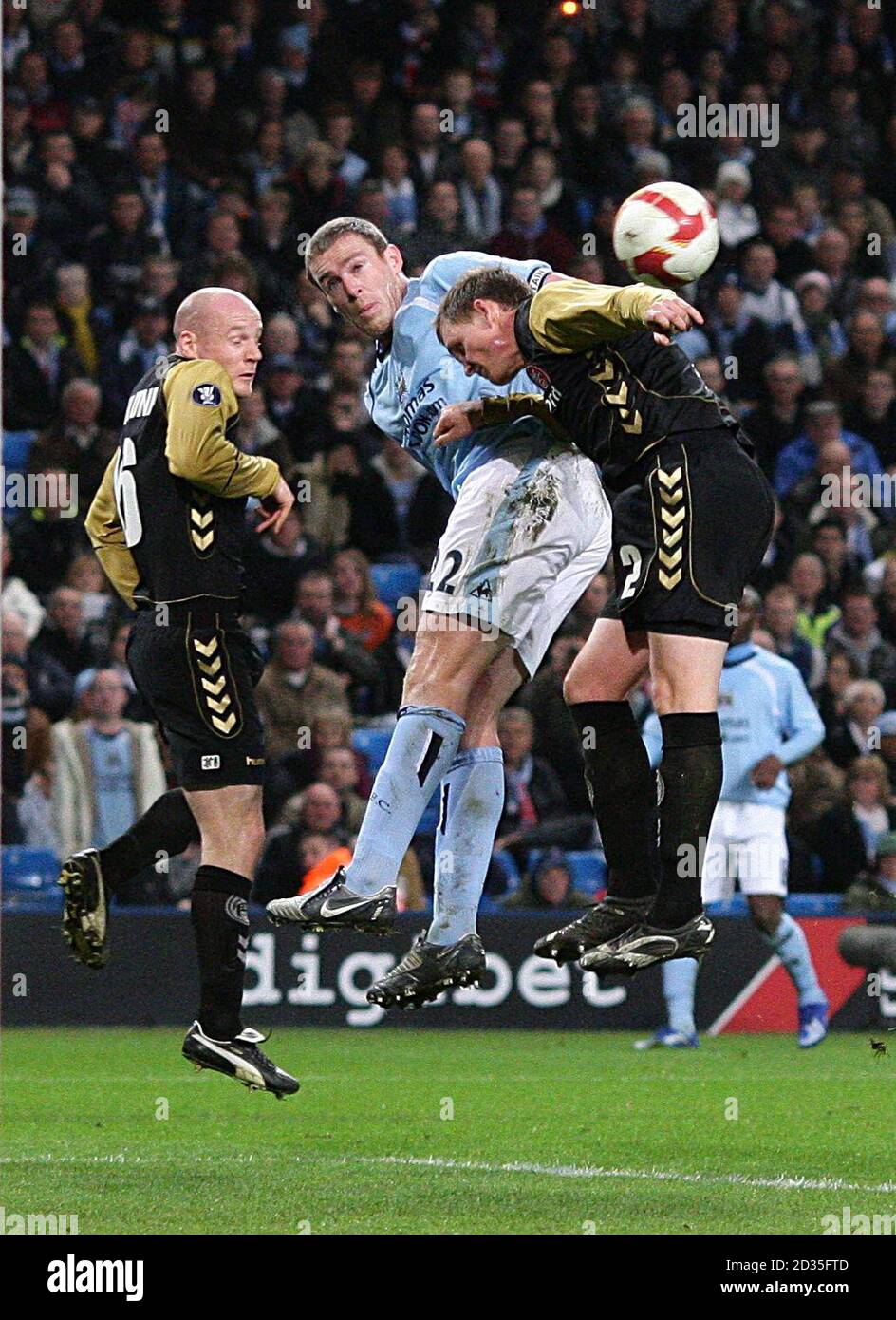 Manchester City's Richard Dunne (centre) and AaB aalborg's Michael ...