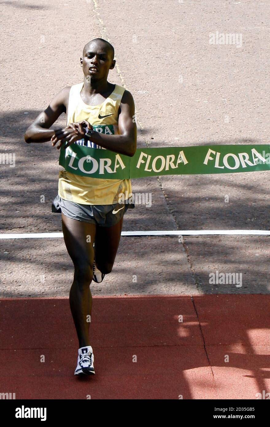 Kenya's Samuel Wanjiru crosses the finish line to win the Men's Elite ...