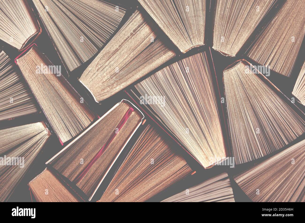 Book background from multi-colored open books from the home library ...