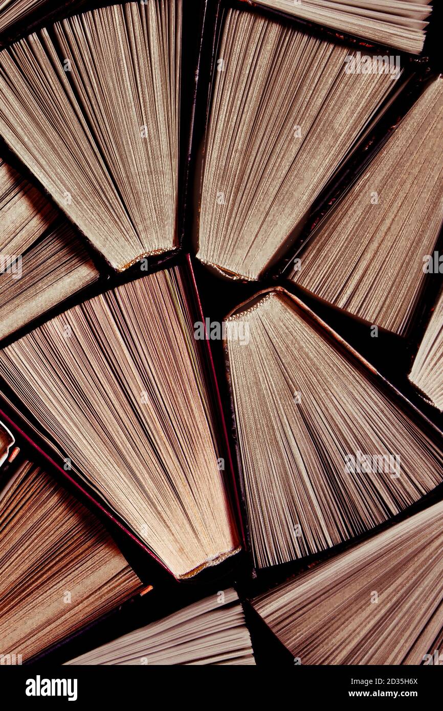 Book background from multi-colored open books from the home library ...