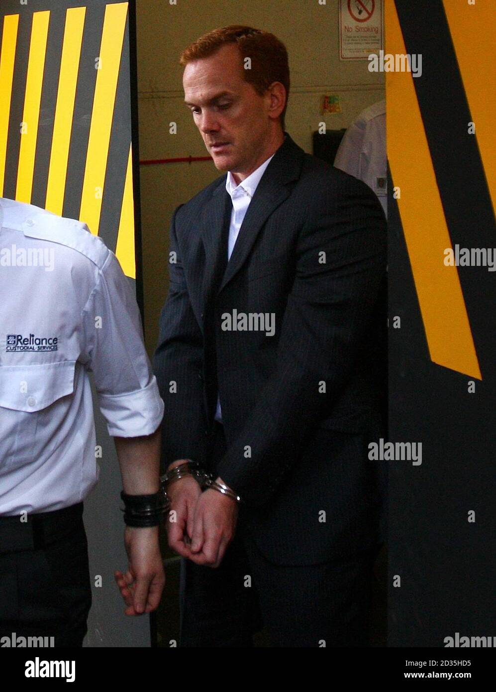 Supermarket worker Robert McCulloch is led away from the High Court in ...