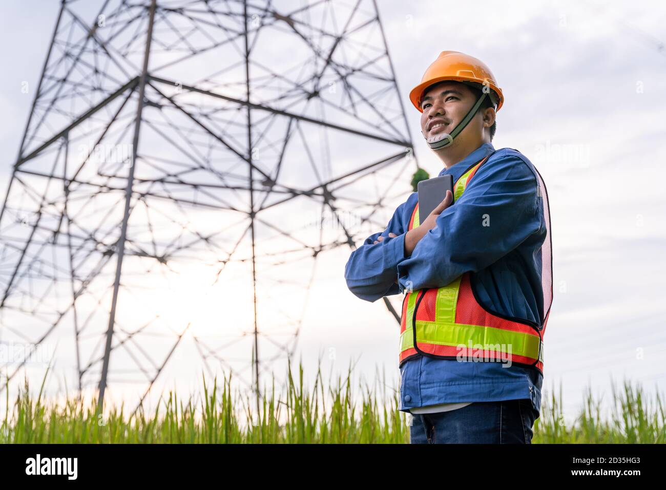 Picture of Asian engineering wear safety clothes and embrace the tablet ...