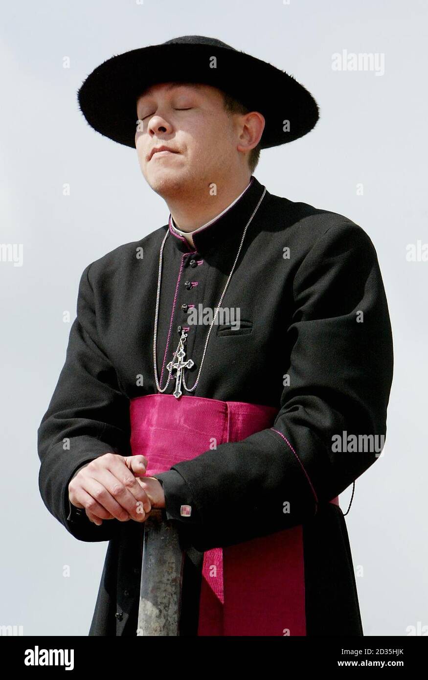 Catholic Priest Father Jerome Lloyd prays after climbing to the top of ...
