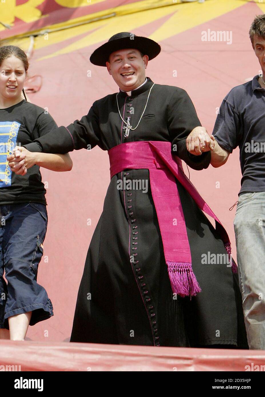 Catholic Priest Father Jerome Lloyd is brought down from the top of ...