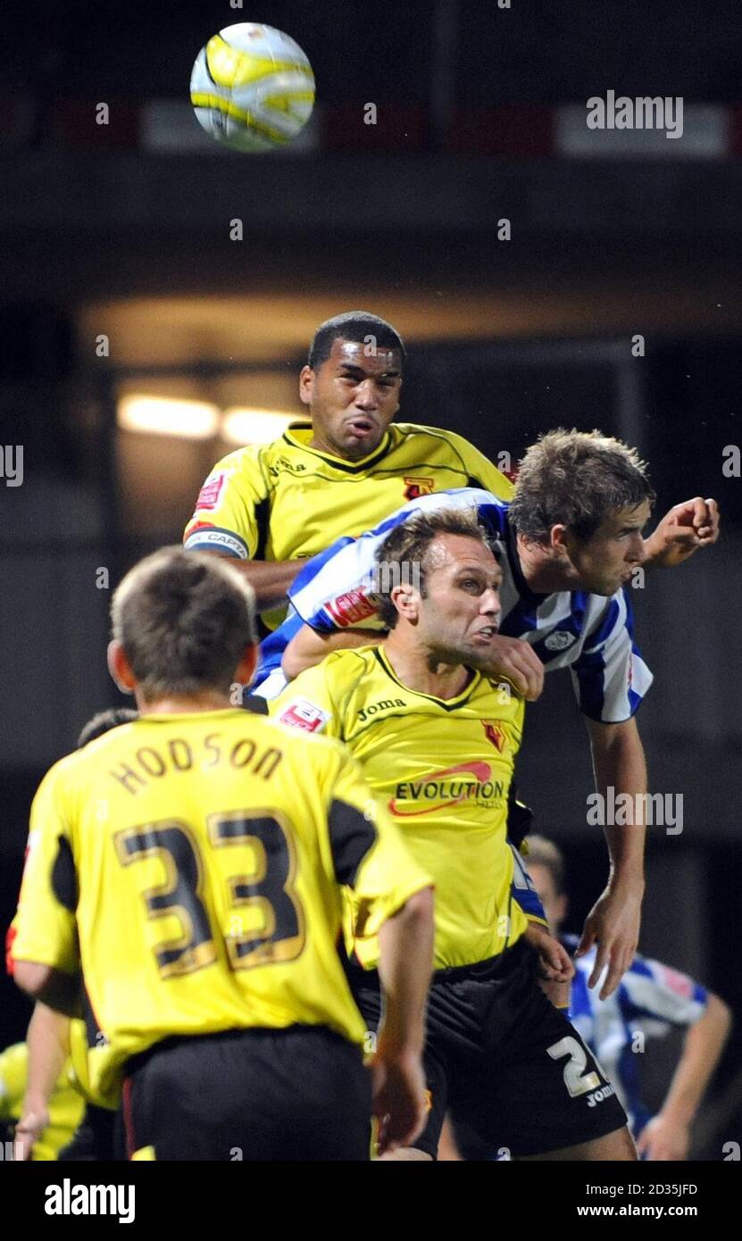 Watford's Adrian Mariappa (back) wins a header during the Coca-Cola ...