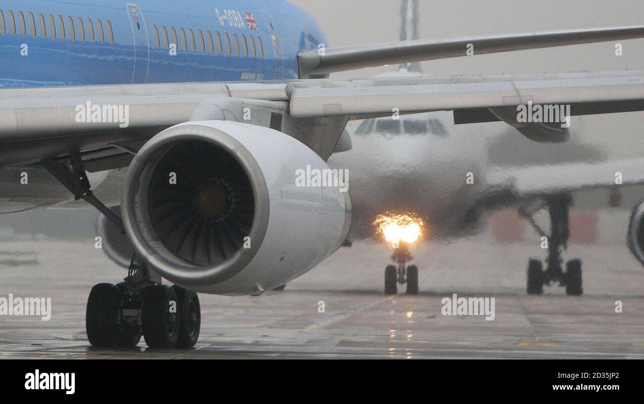 Two planes queue ahead of take off at Manchester Airport Stock Photo ...