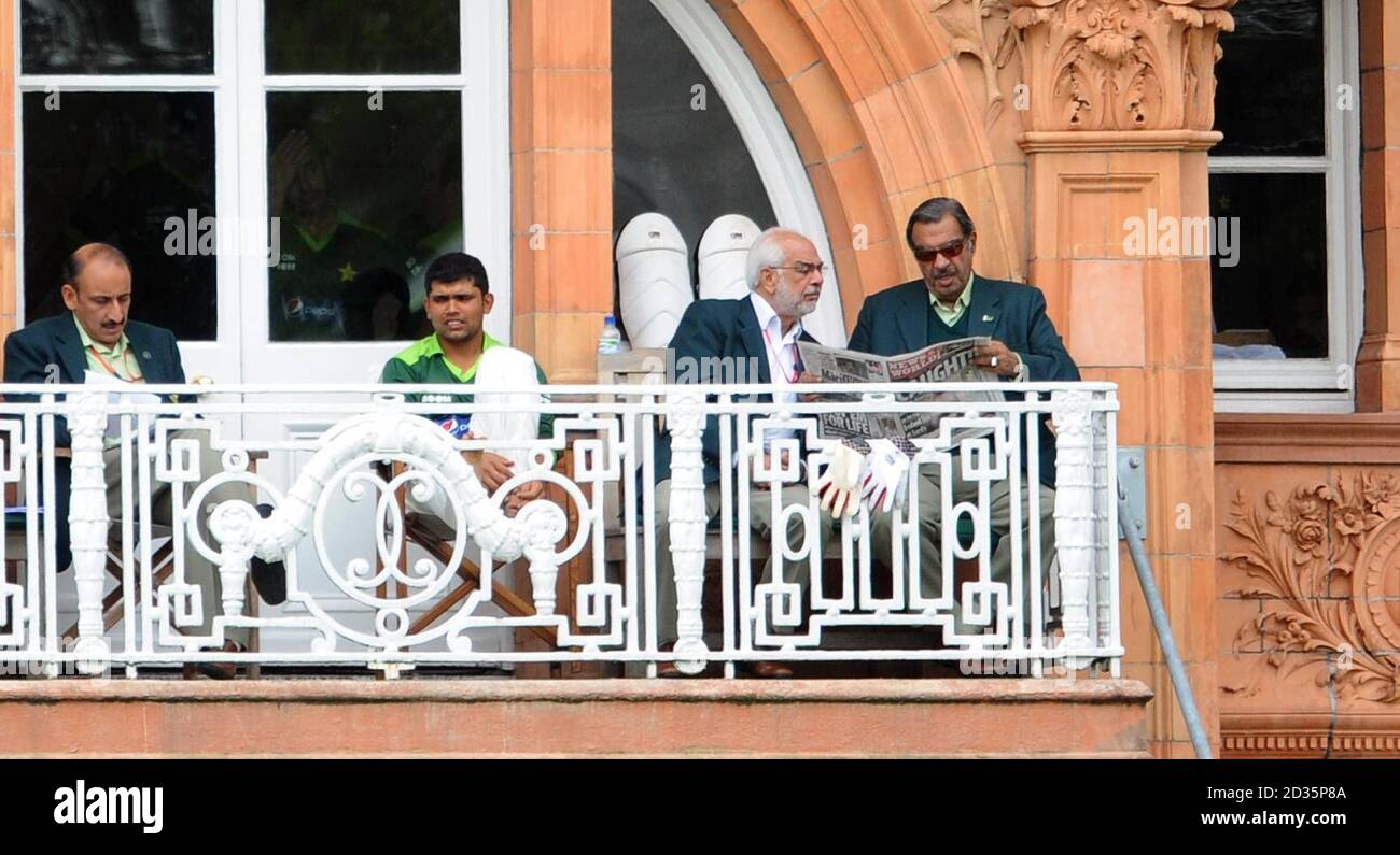 Pakistan team manager Yawar Saeed reads a copy of the News of the World ...