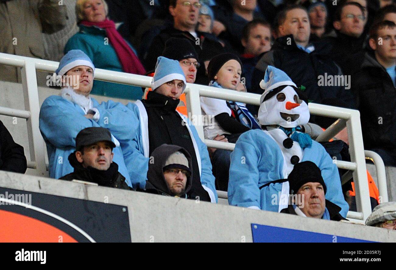 Manchester City fans dress up in the stands Stock Photo - Alamy