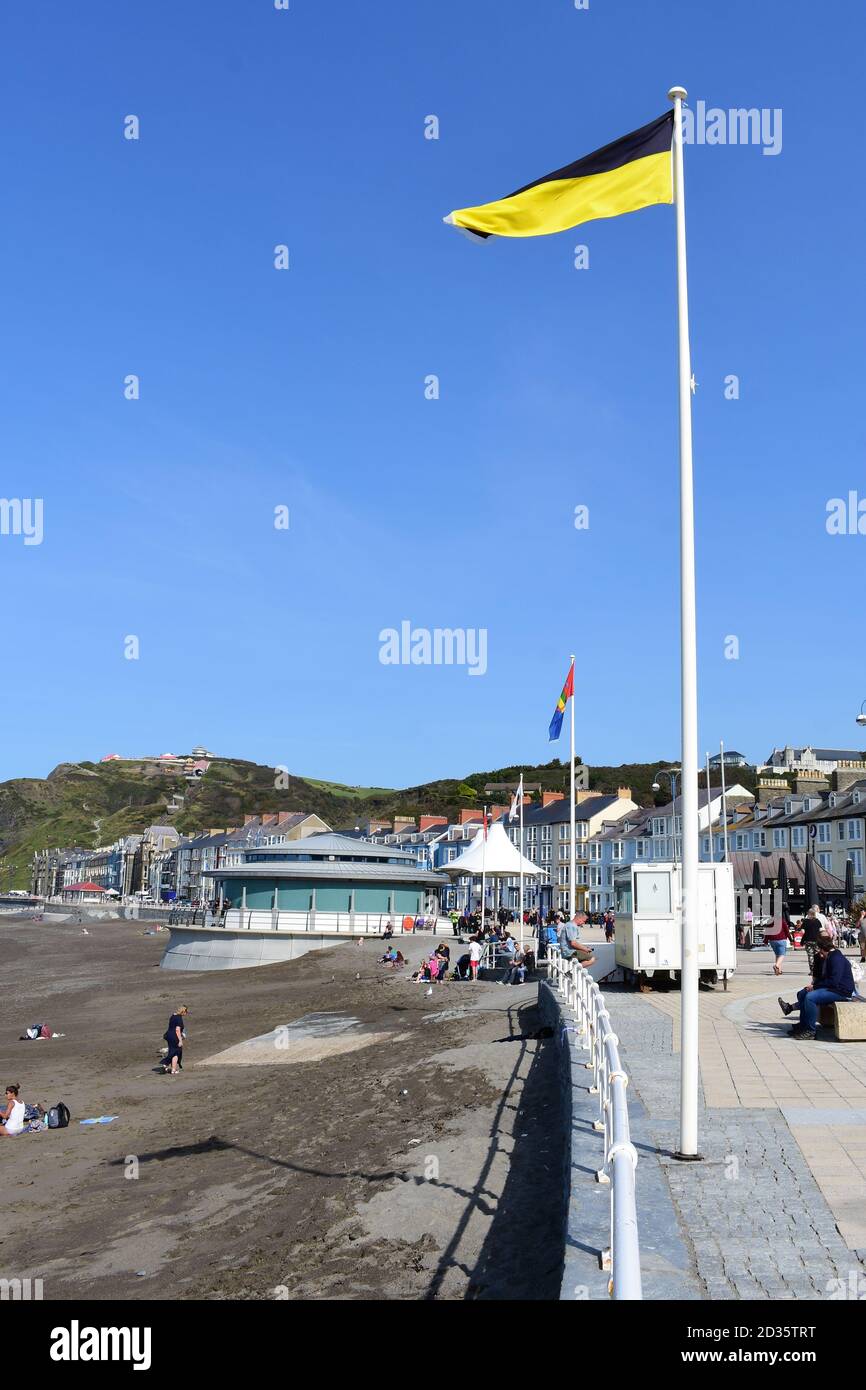 A view of the seafront promenade & beach at Aberystwyth. People playing ...