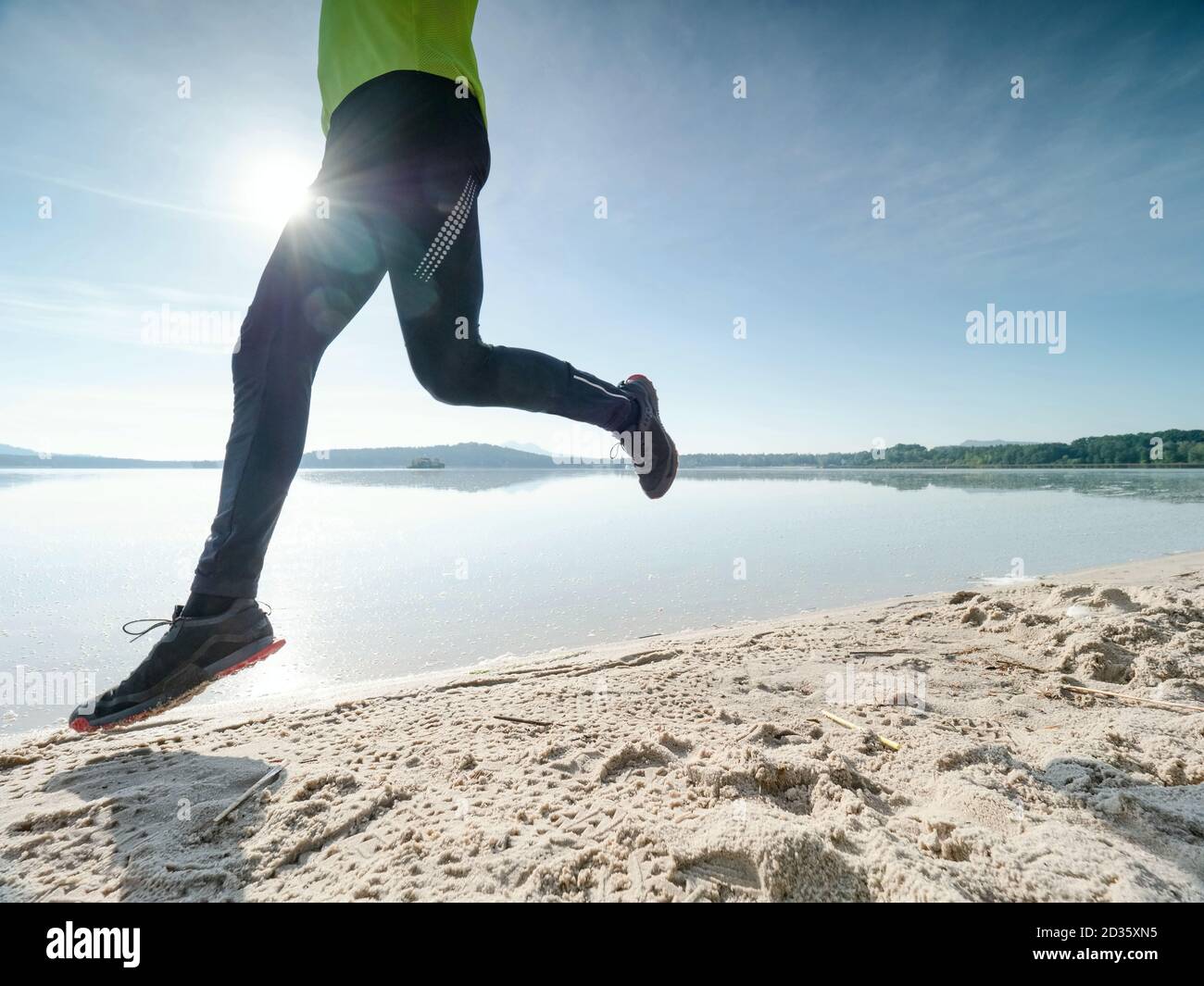 Run on beach. Runner along lake. Misty morning spent on beach at lake ...