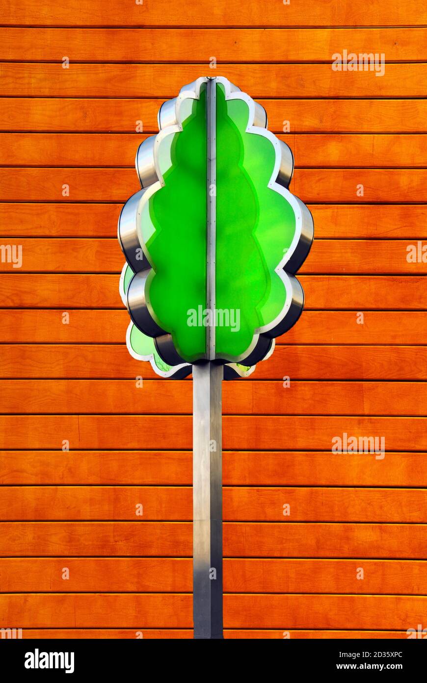 Neon green tree against bright orange wooden background wallart Stock ...