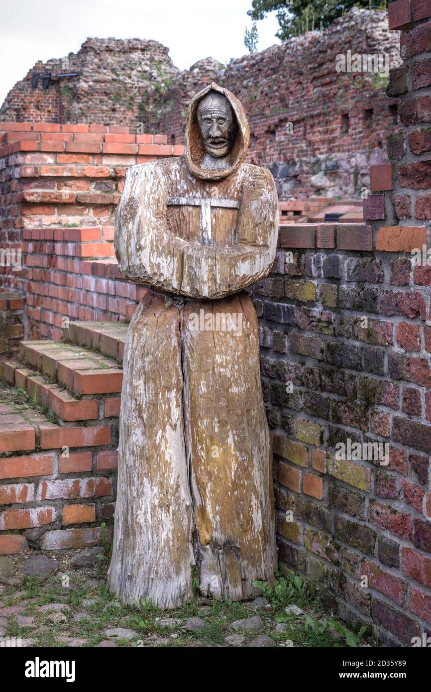 Poland, Torun: Wooden statue of a medieval monk among the remnants of ...