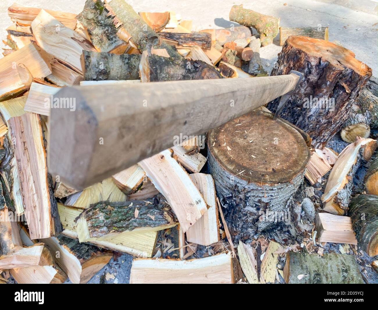 Ax stuck in a tree stump. Woodcutter's ax on the stump Stock Photo - Alamy