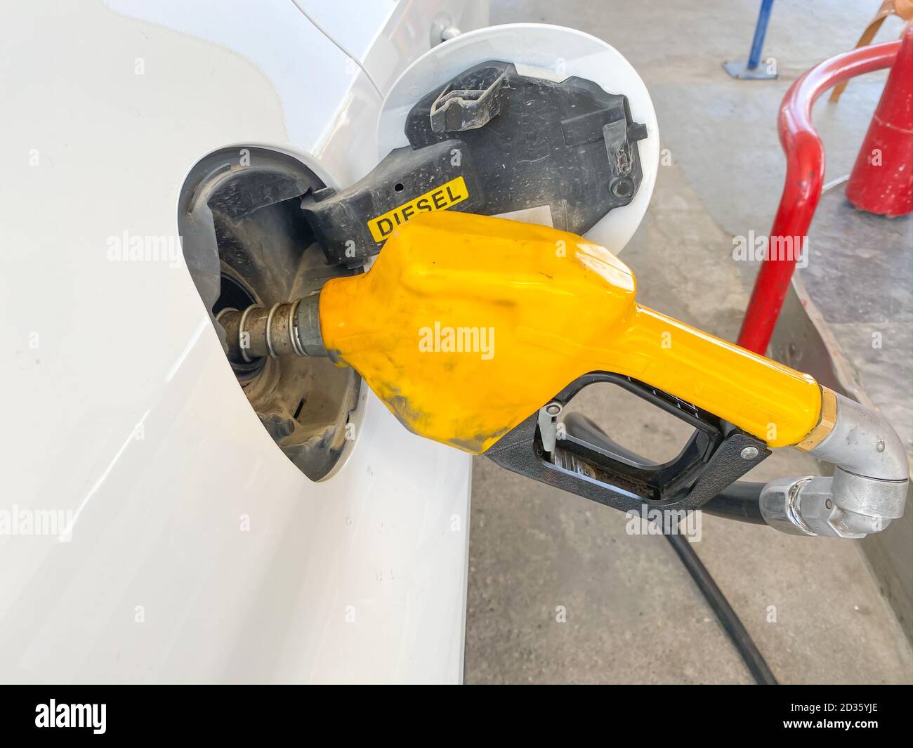 Small white car refuelling at the gas station. Car refueling on the ...