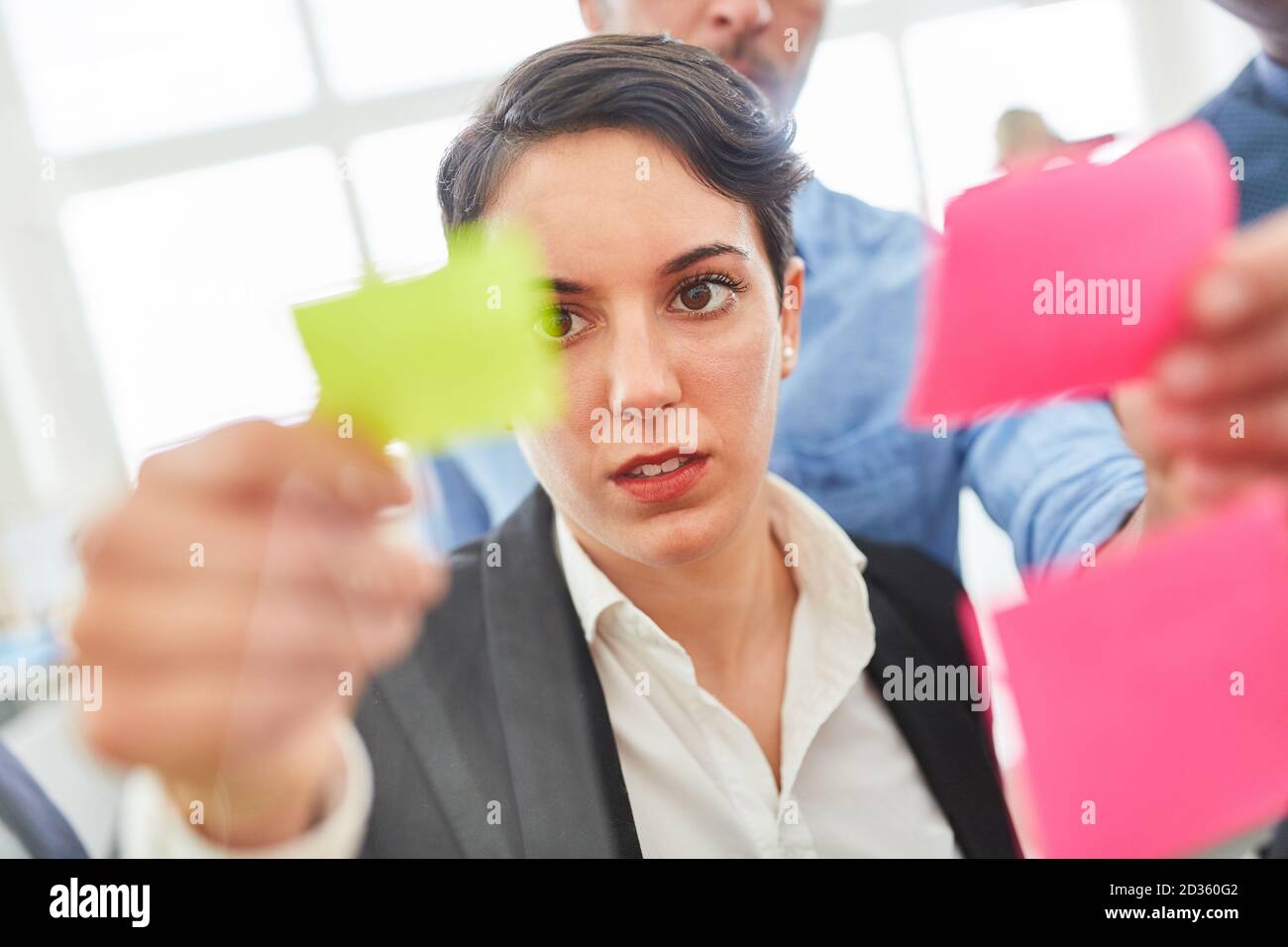 Business woman looks at a piece of paper with project ideas in the ...