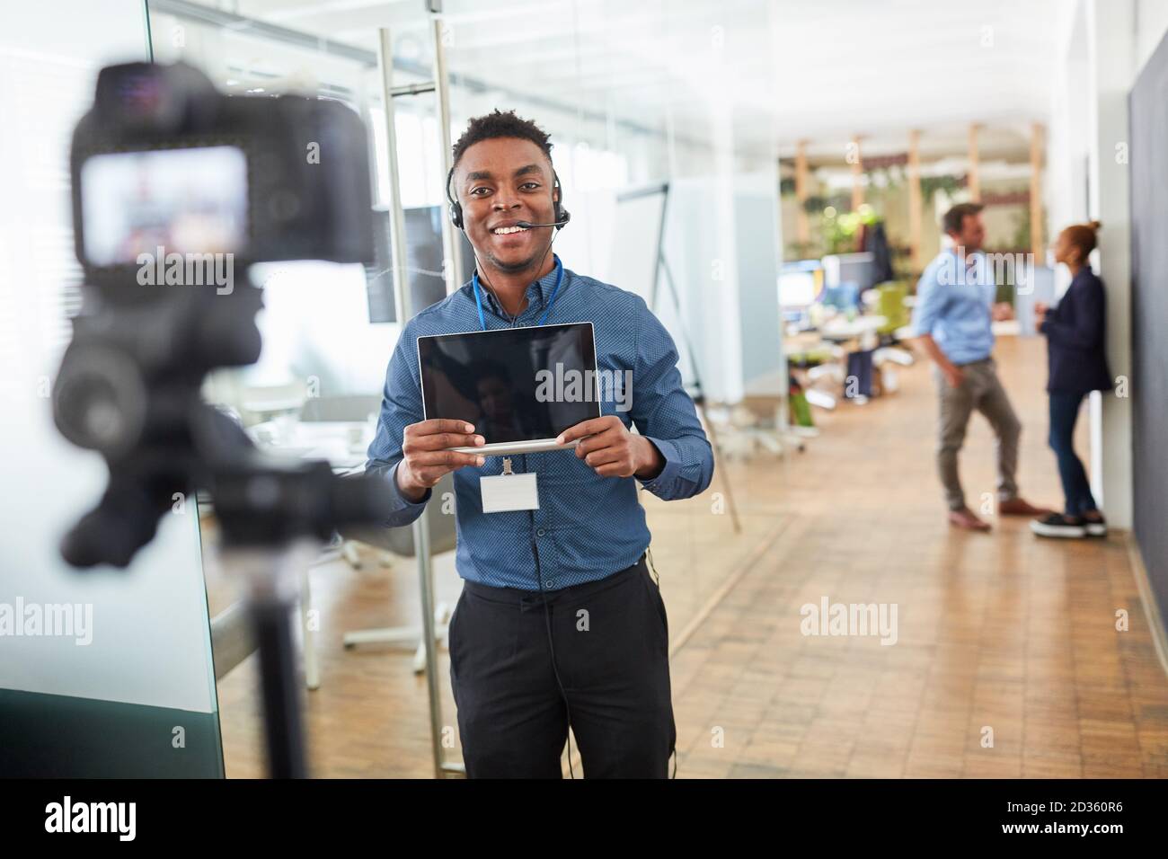 Young business man in front of the video camera while streaming live ...