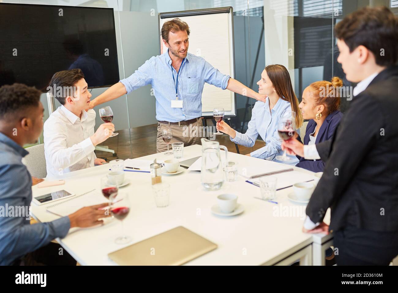 Proud boss or managing director celebrates a success with his team with ...