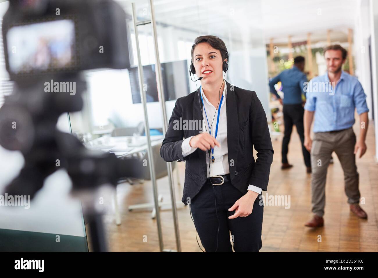 Business woman with headset while recording video for a live report ...