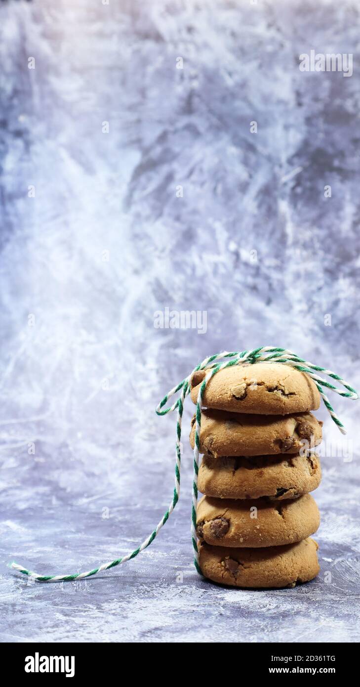 American chocolate chip cookies stacked on top of each other with green ...
