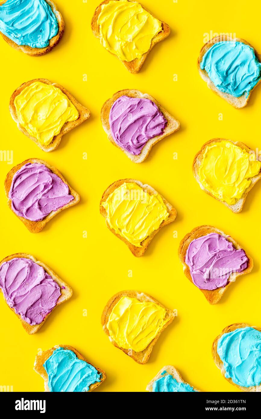 Pattern of toast bread with colored cheese spread. Layout top view ...