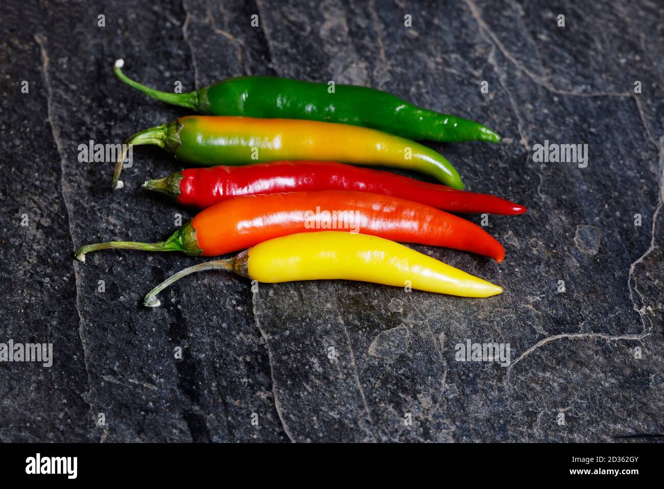 Different Chili on a stone plate Stock Photo - Alamy