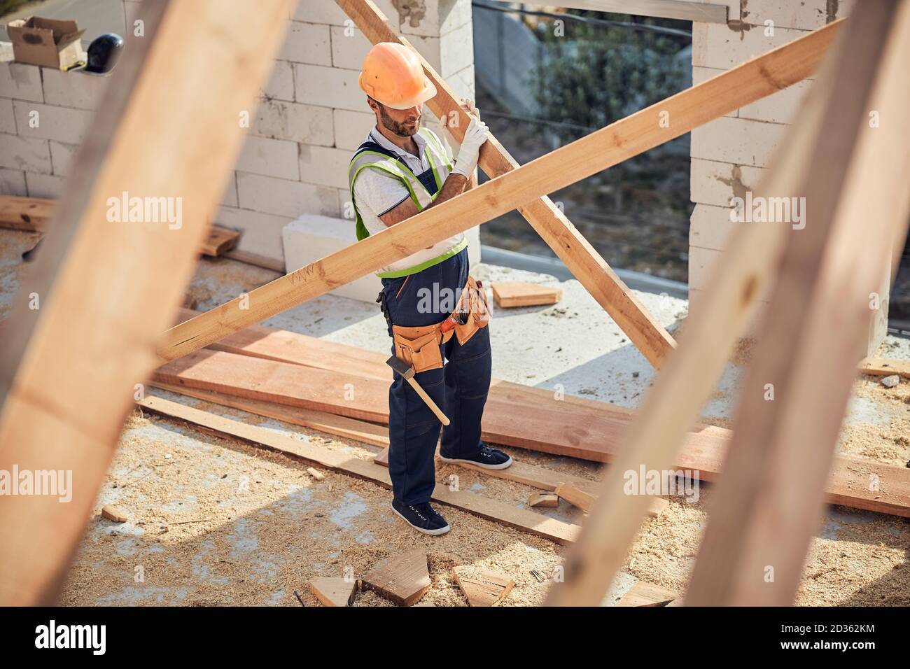 Hard-working man working with wood in a construction site Stock Photo ...