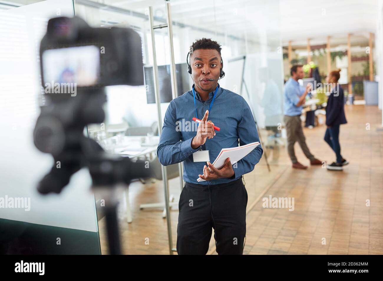 Business man with headset while recording video for a coaching tutorial ...