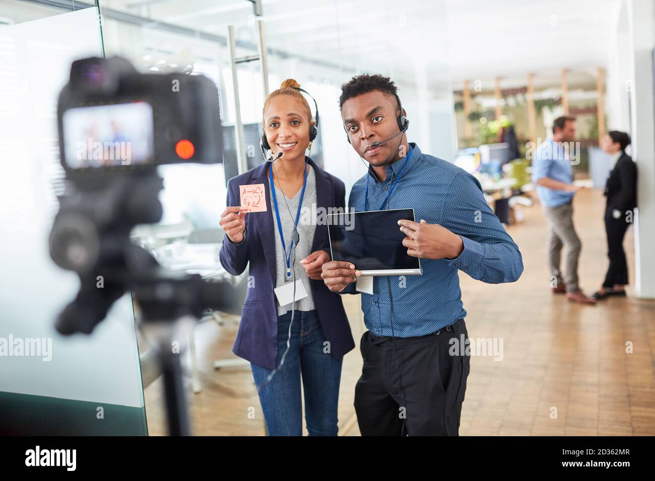 Business people with headset in front of the video camera for a ...
