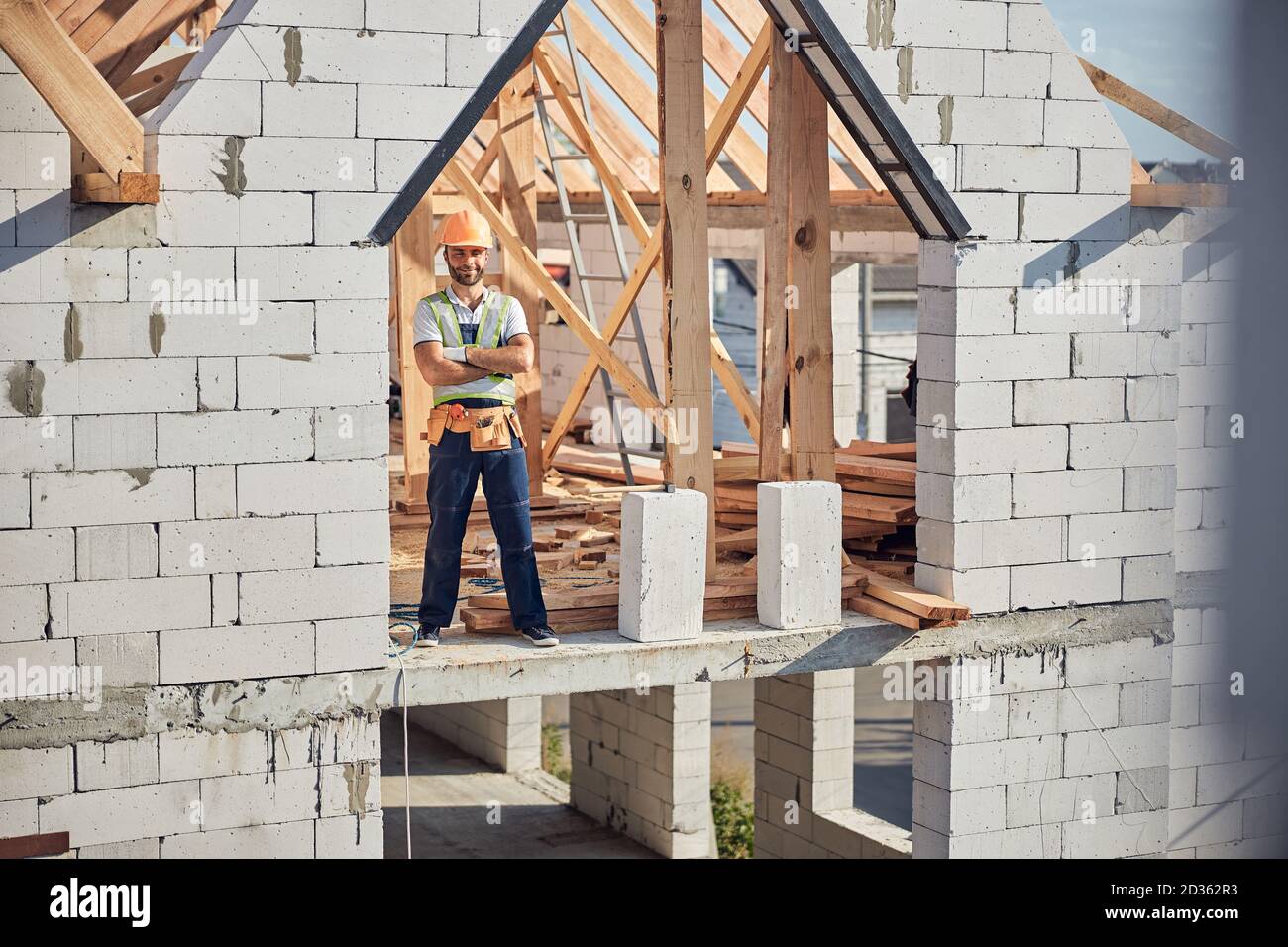 Professional builder posing in a construction site Stock Photo - Alamy