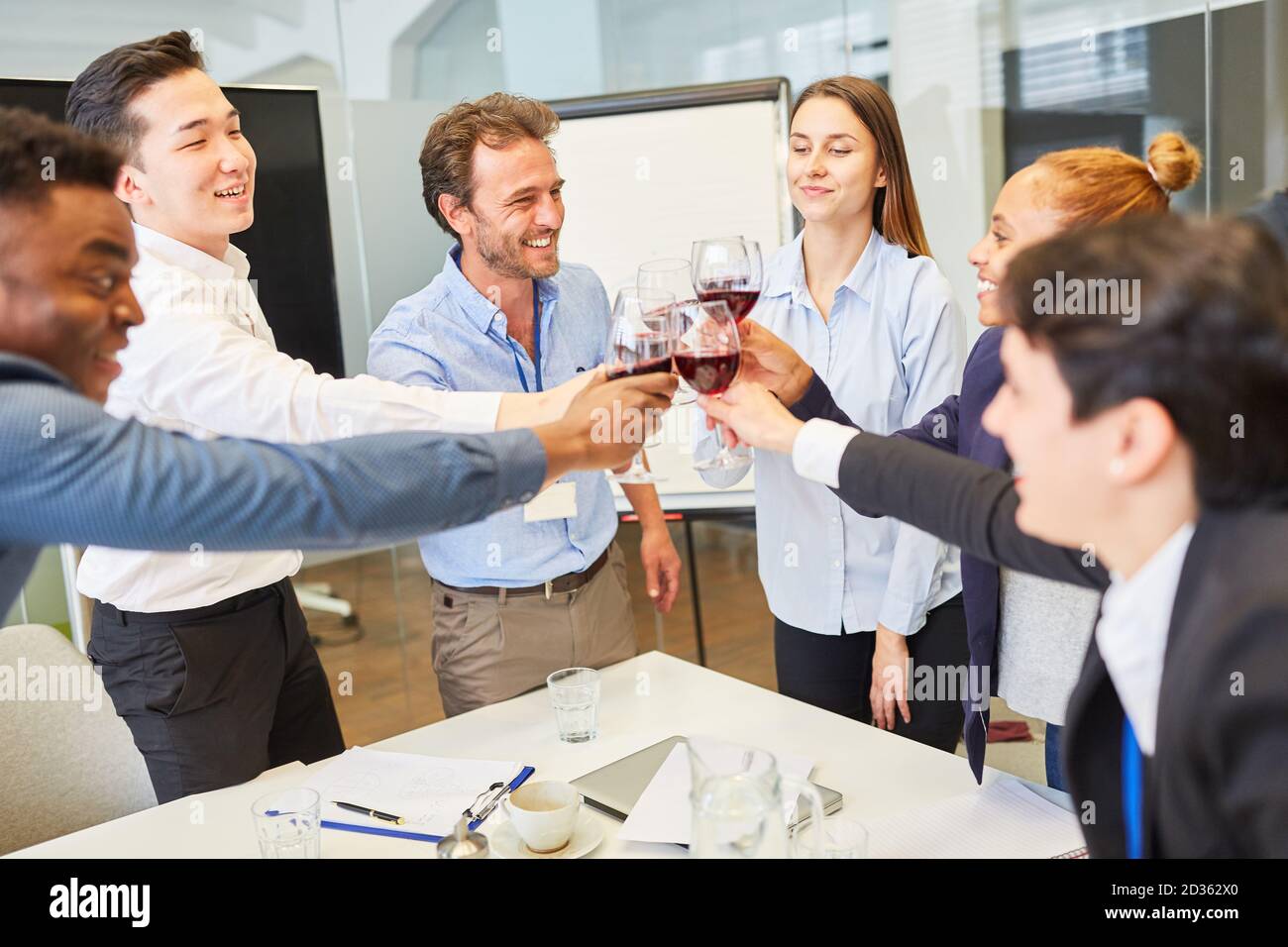 Group of business people toasting with a glass of wine after a success ...