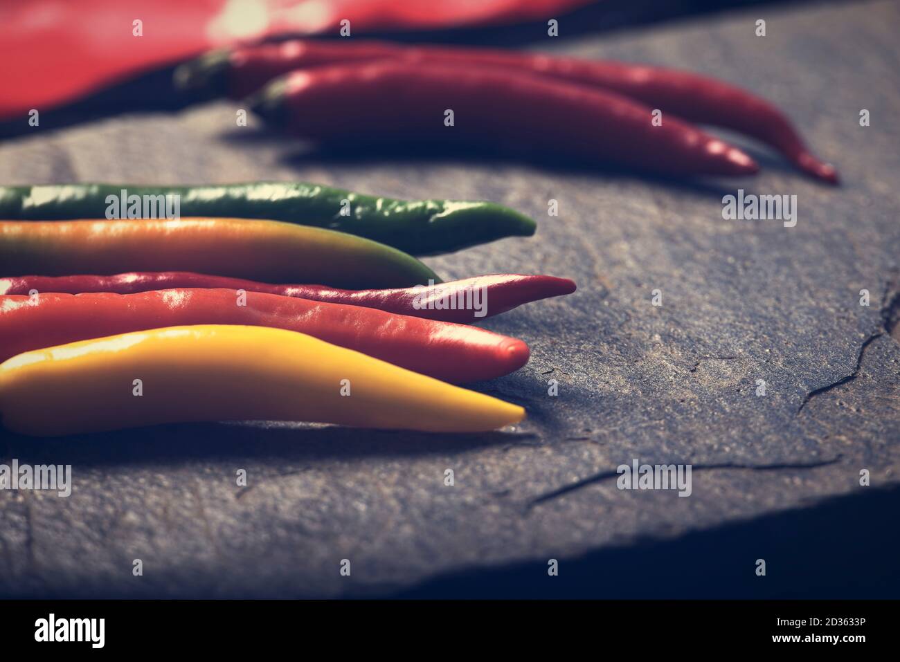 Different Chili on a stone plate Stock Photo - Alamy