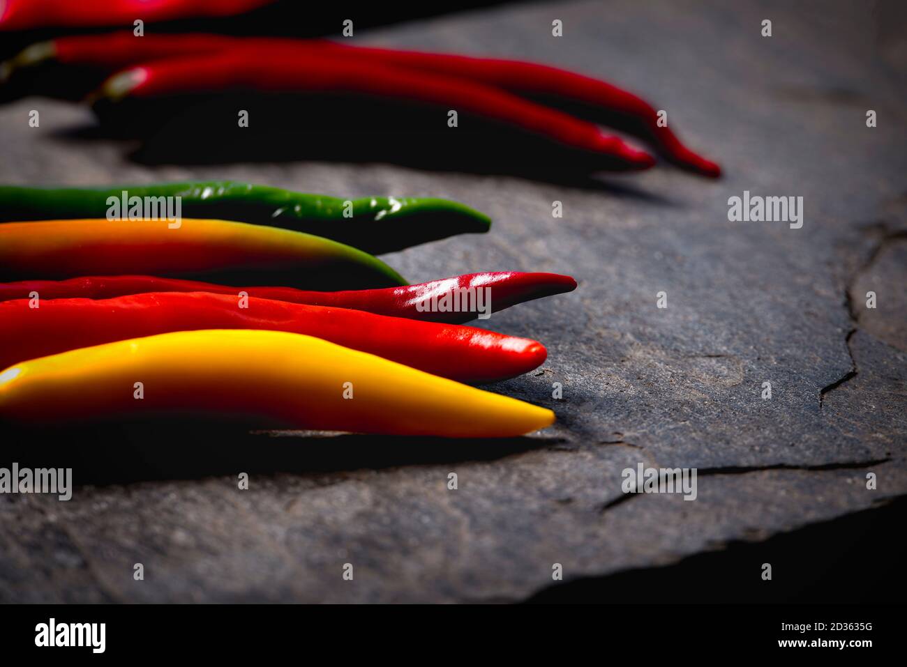 Different Chili on a stone plate Stock Photo - Alamy