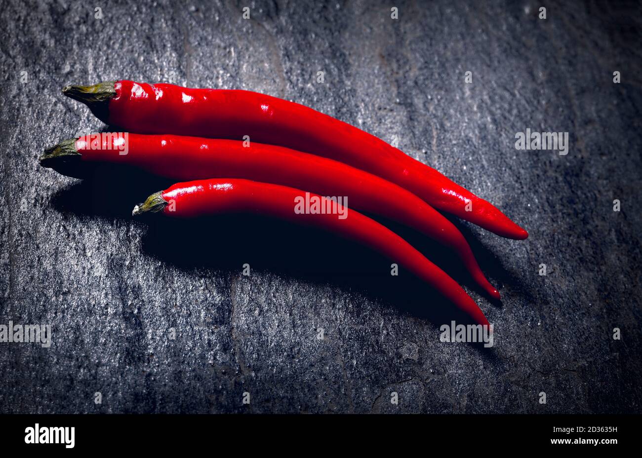 Different Chili on a stone plate Stock Photo - Alamy