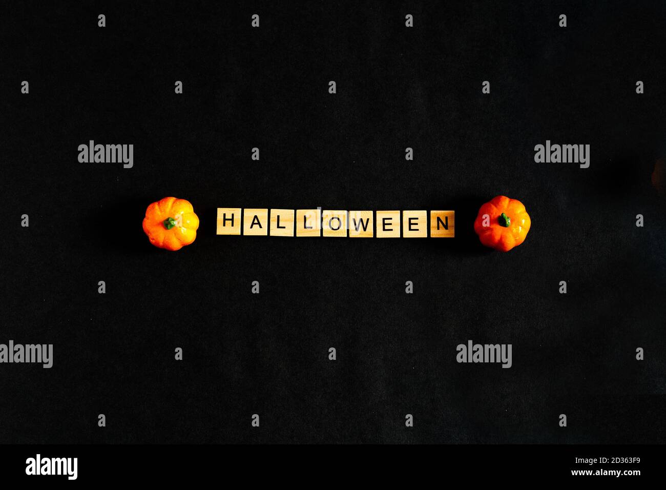 Words Halloween. Wooden blocks with lettering on black background ...