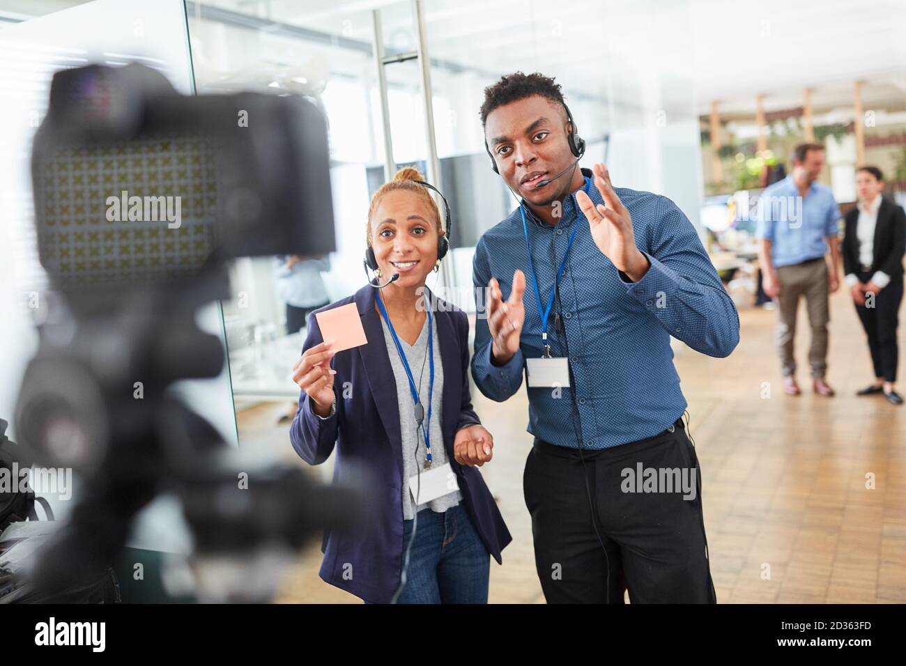 Business people or reporter team in front of the video camera while ...