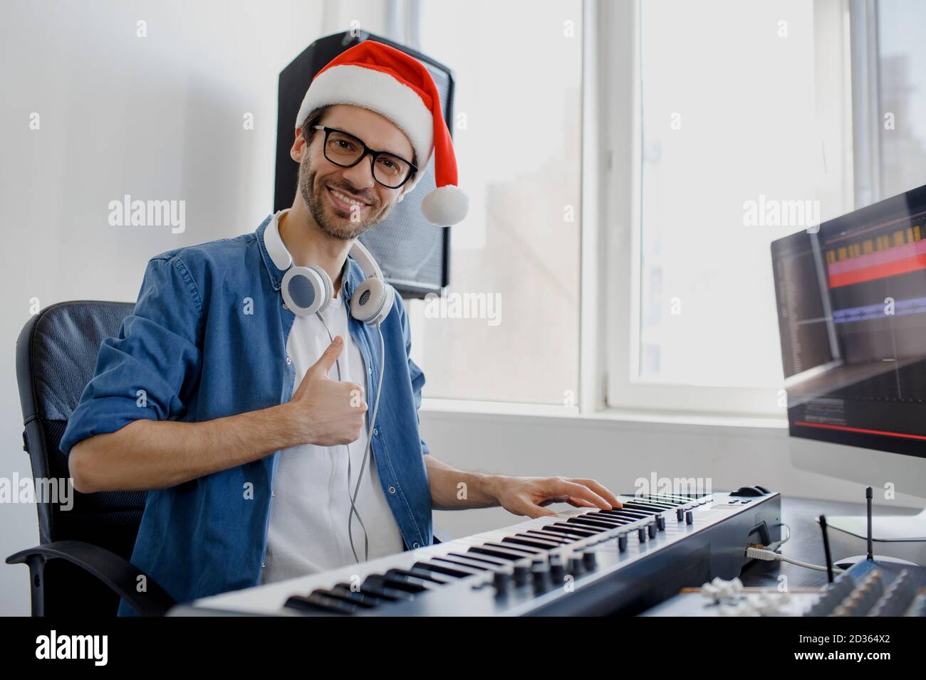 Thumb up. Merry Christmas and a happy new year Composer hands on piano ...