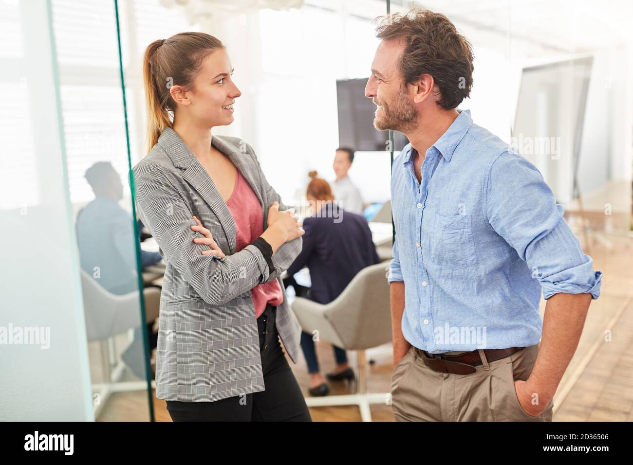 Casual conversation between two business team colleagues in the office ...