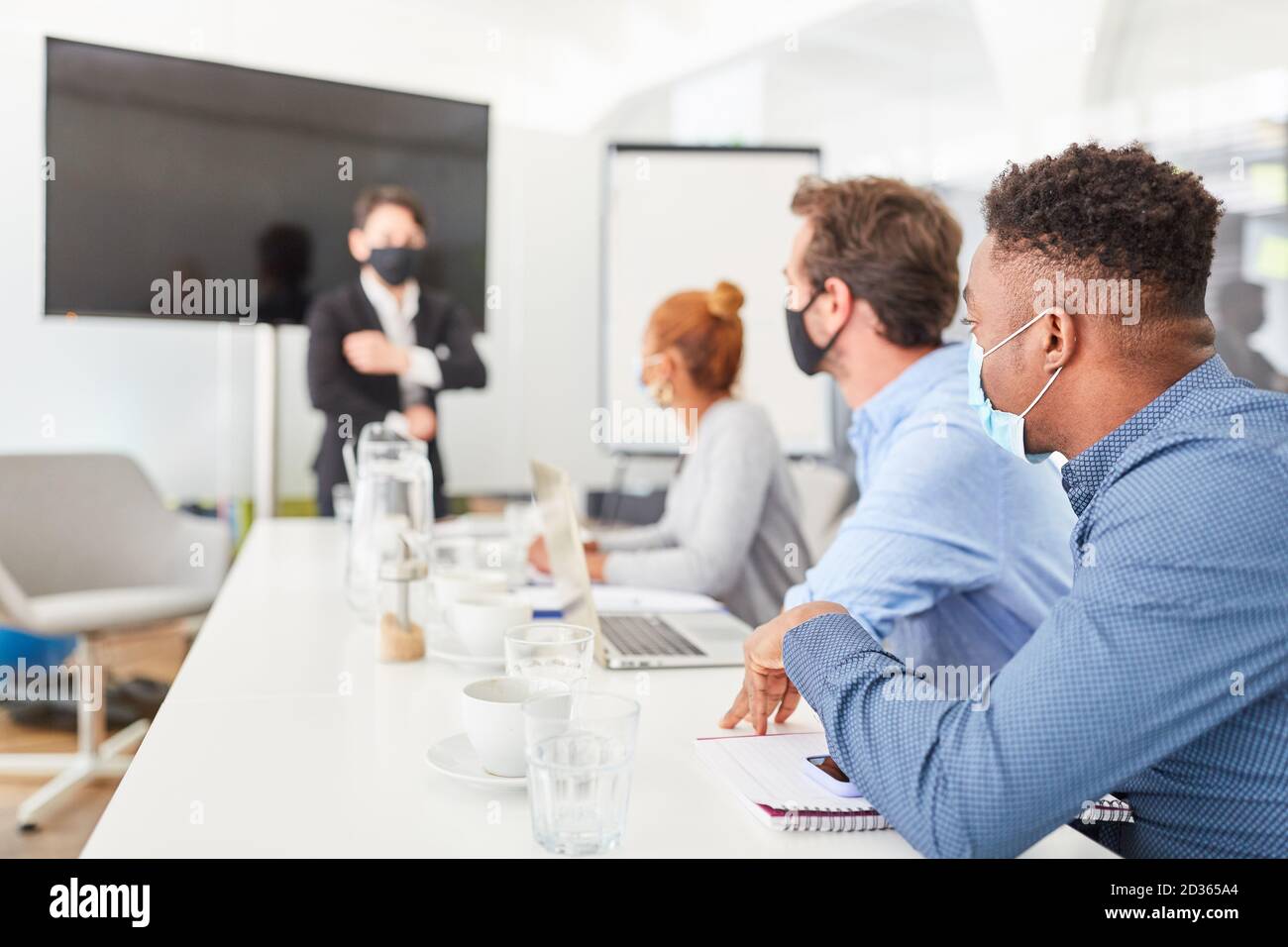 Students or business people in a seminar giving a lecture or ...