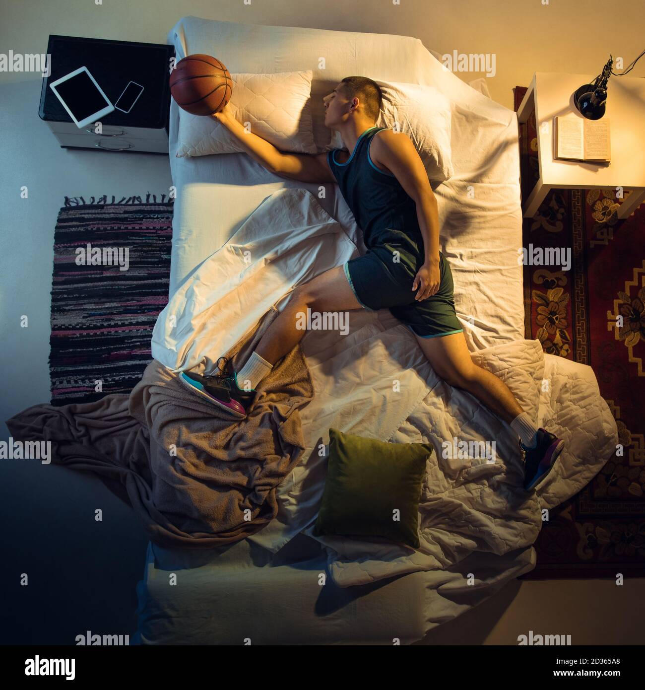 Goal. Top view of young professional basketball player sleeping at his ...