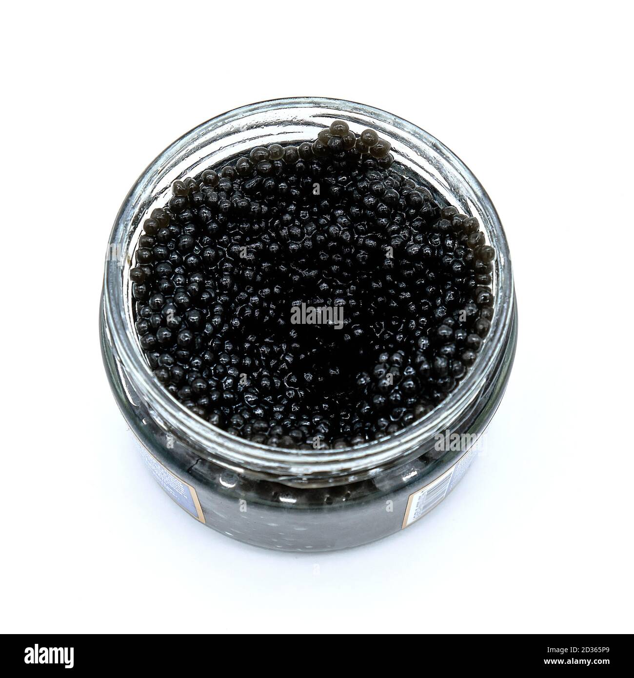 Open glass jar of black caviar on isolated white background. A delicacy ...