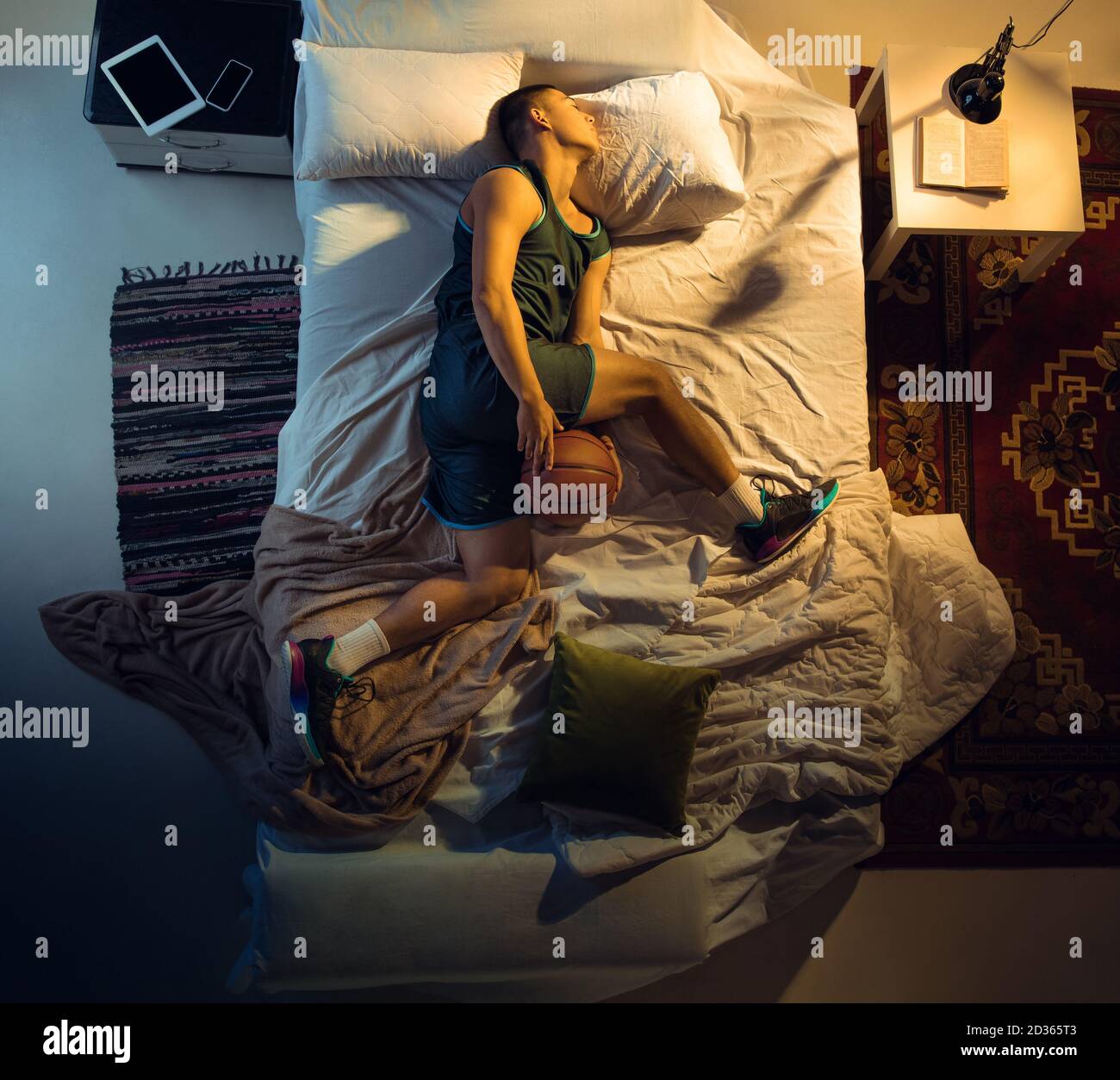 Slam dunk. Top view of young professional basketball player sleeping at ...