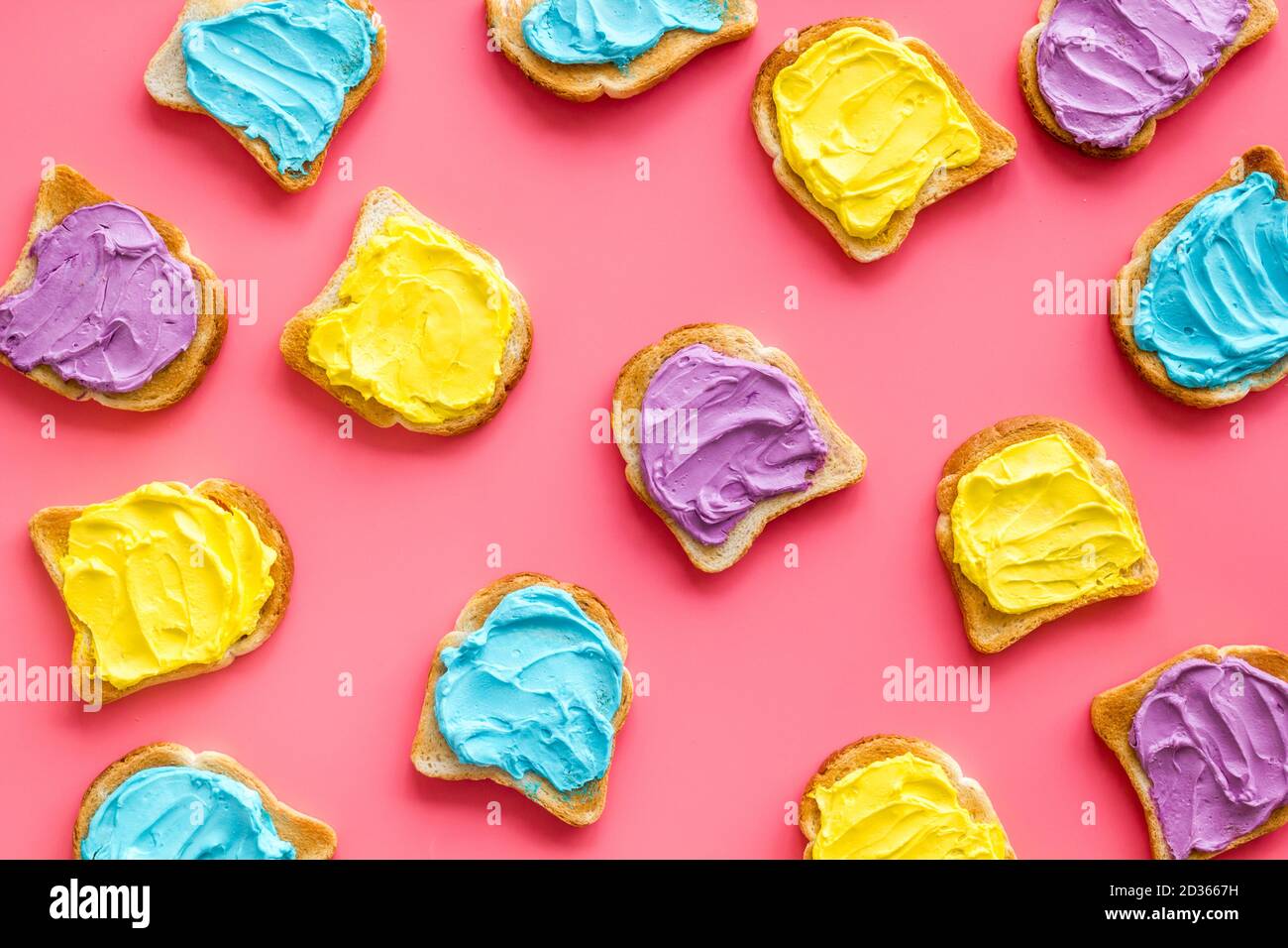 Pattern of toast bread with colored cheese spread. Layout top view ...