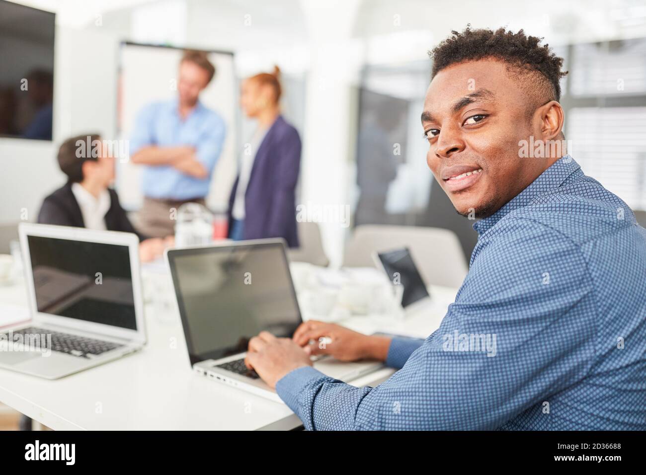 African programmer or creative developer working on laptop computer ...
