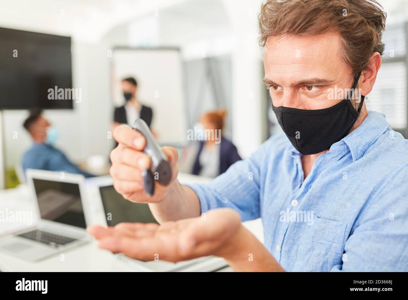 Businessman disinfecting hands hi-res stock photography and images - Alamy