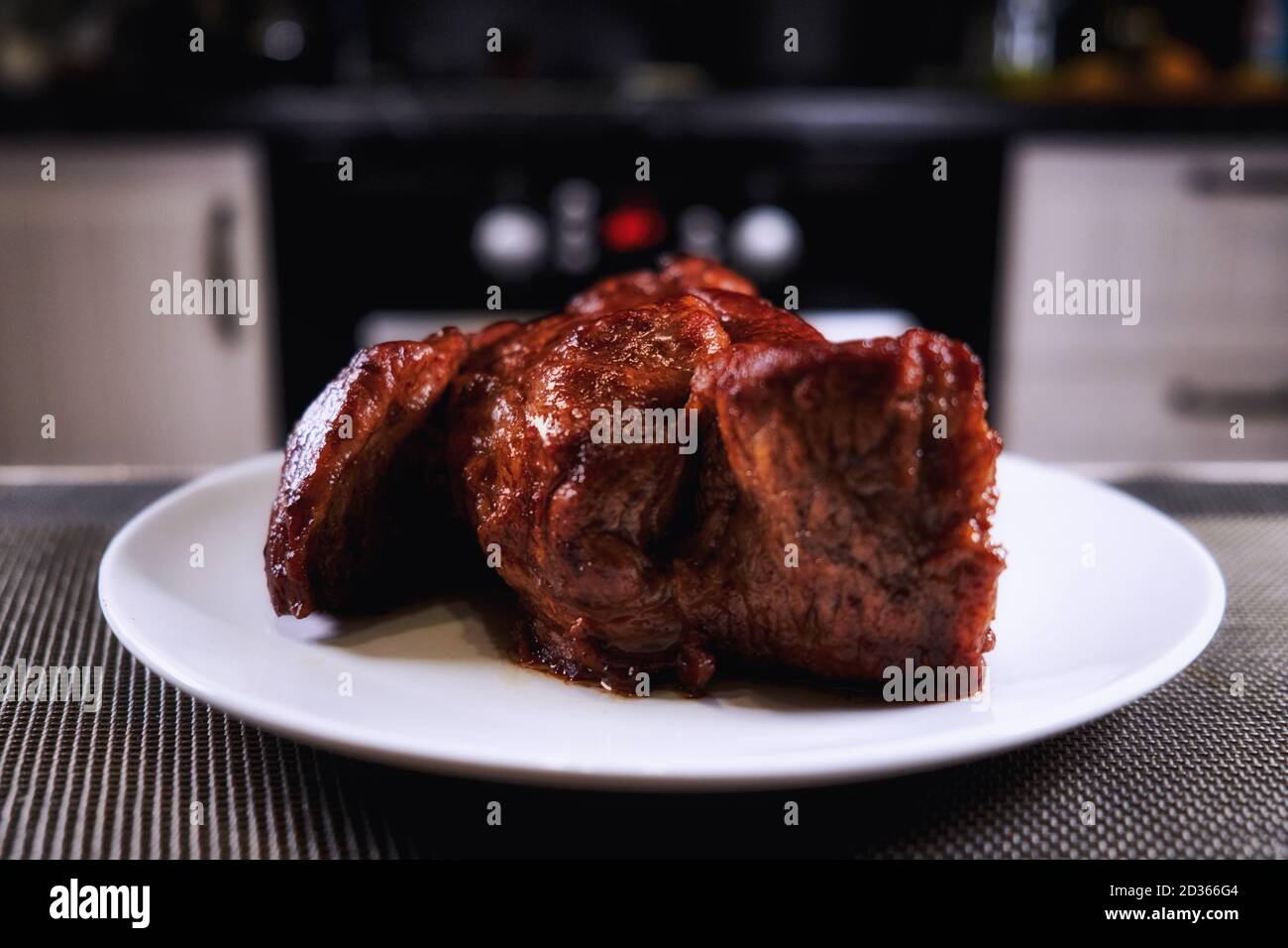 Big piece of meat on plate. Roast beef close-up. Barbecue meat in ...
