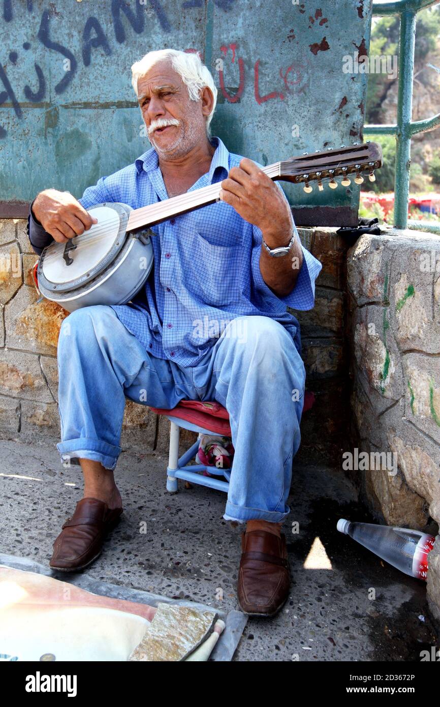 A street performer plays his banjo on the stairs leading down to the ...