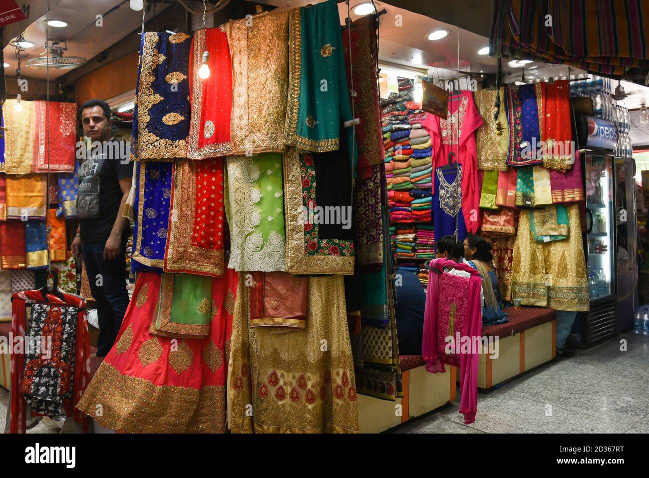 DELHI, INDIA - MAY 14: Sales man at shop selling traditional Indian ...